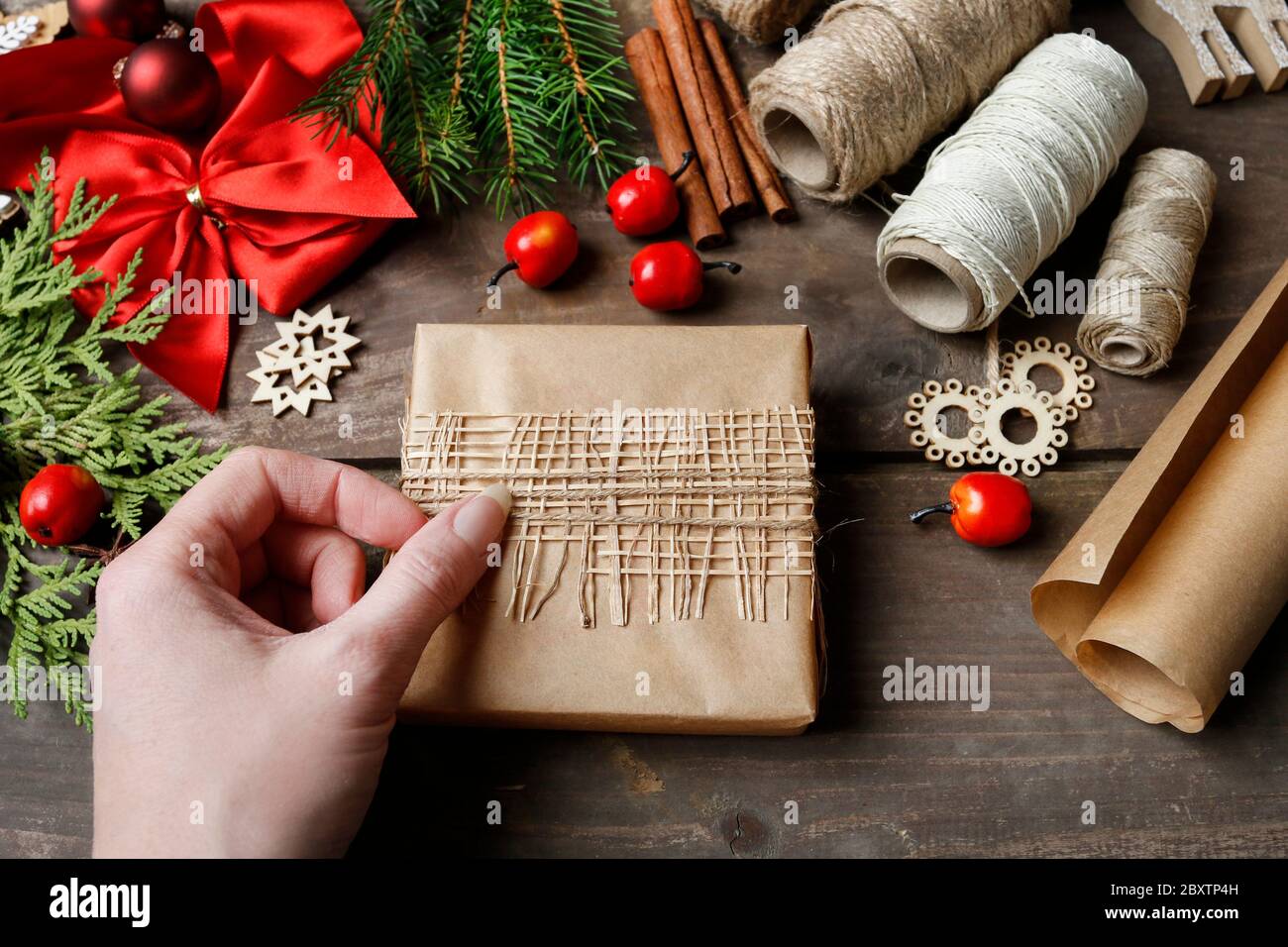 Woman shows how to beautifully pack Christmas presents. Step by step ...