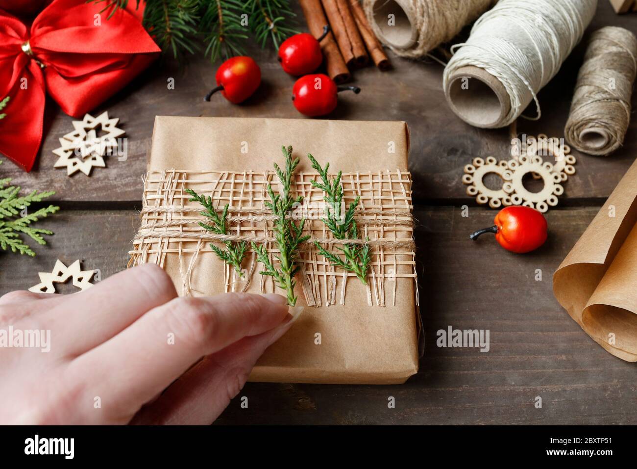 Woman shows how to beautifully pack Christmas presents. Step by step ...