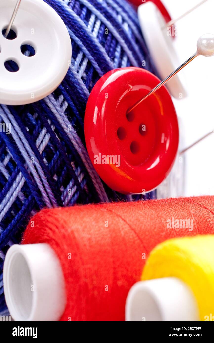 pins in wool ball with buttons Stock Photo - Alamy