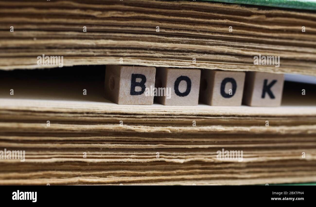 Close up of isolated word book spelled by letter wood tiles between ...