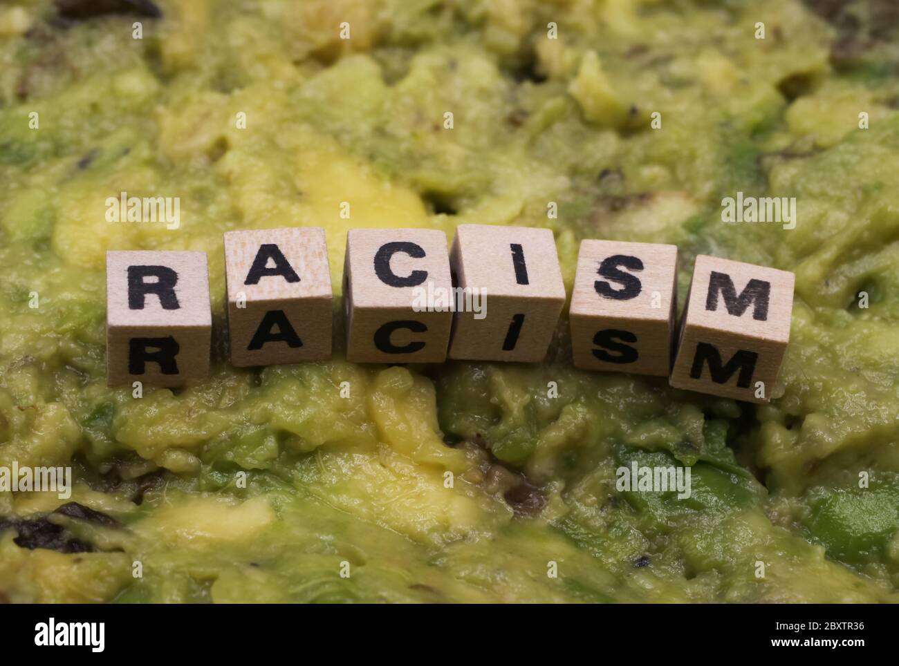 Close up of isolated word racism spelled by wooden letters on ...