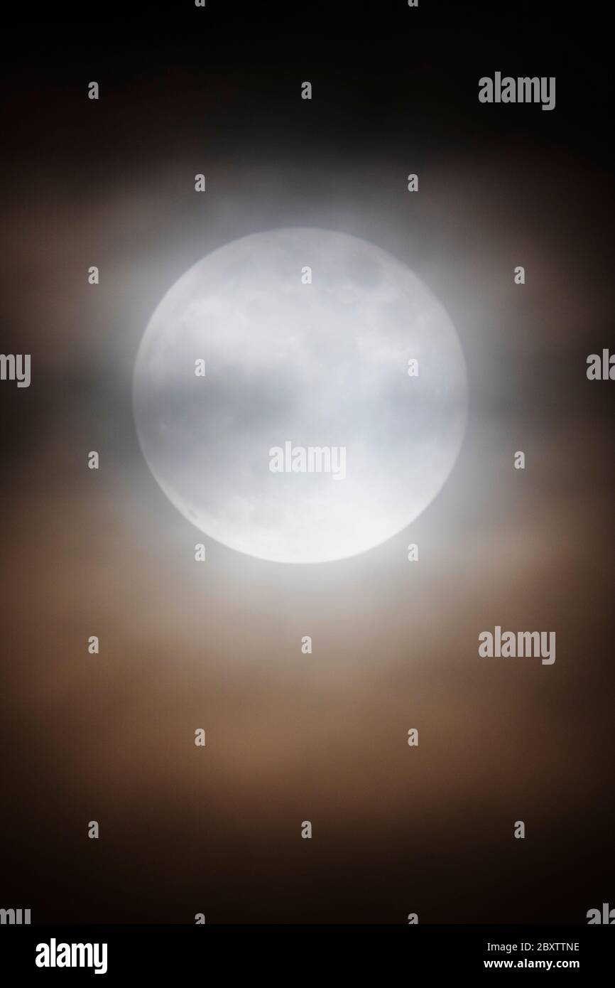 Full Strawberry Moon through clouds over Rocky Mountains, Salida ...