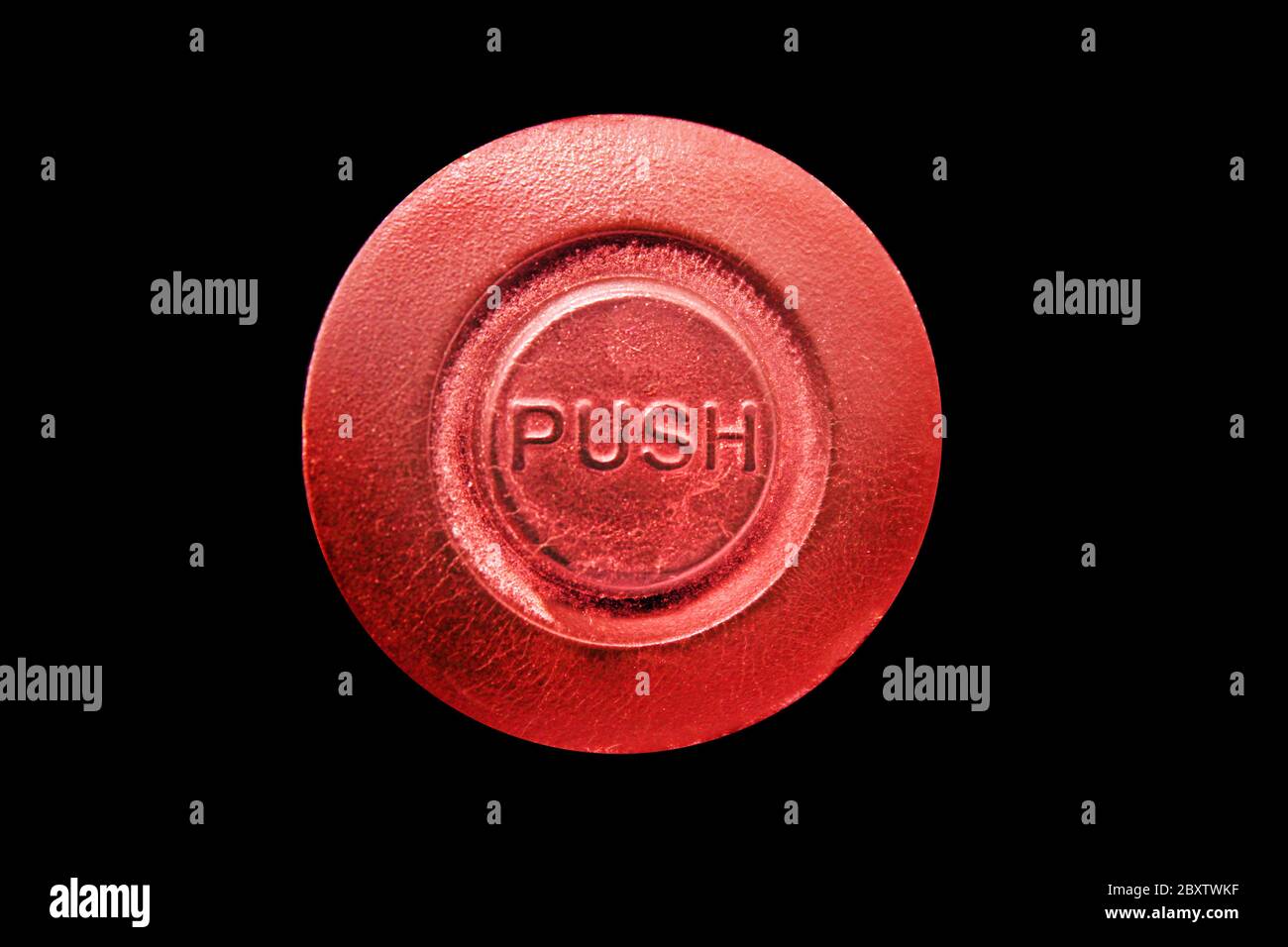 Push red button, isolated on black background Stock Photo - Alamy
