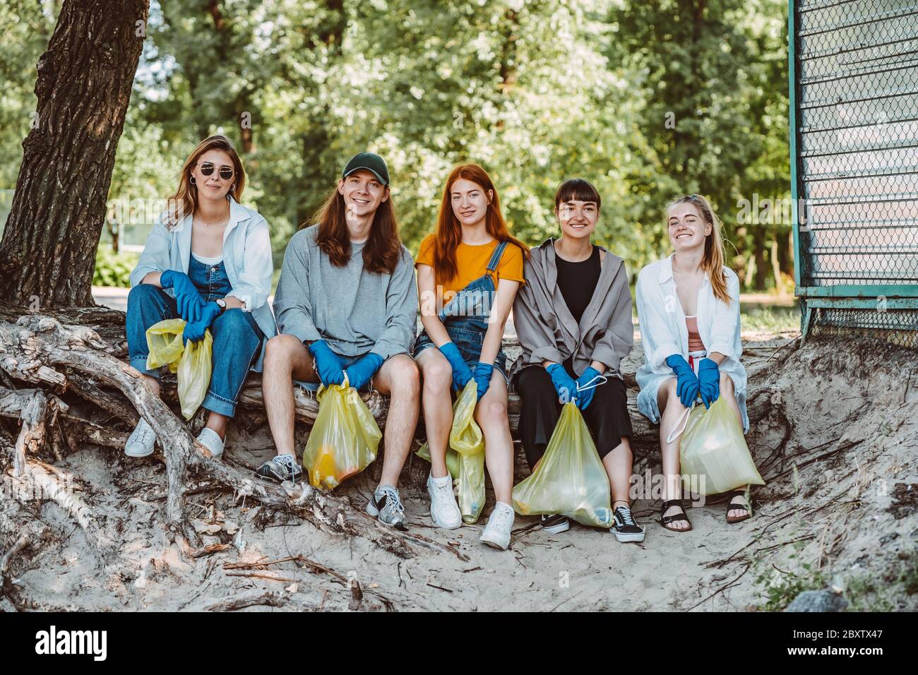 Group of activists friends collecting plastic waste at the park ...