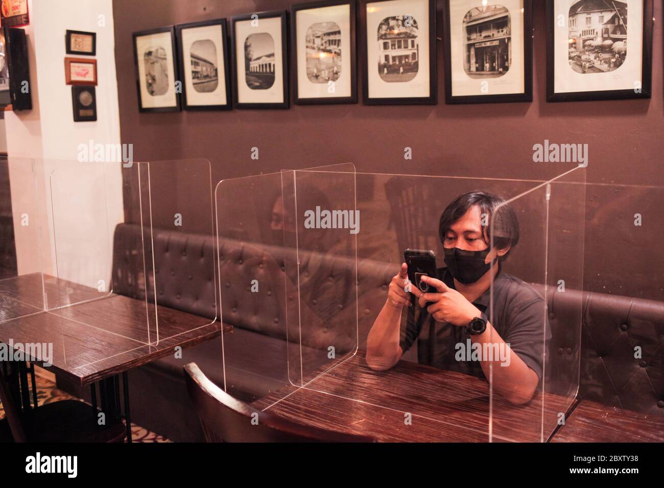 A customer inside a Cafe during the first day of reopening. By ...
