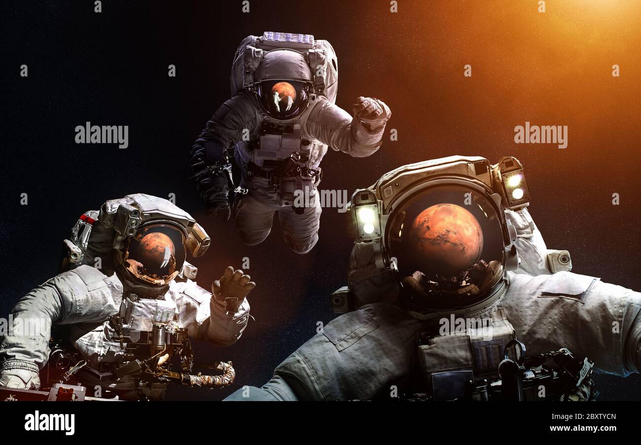 Three astronauts in front of Mars Stock Photo - Alamy