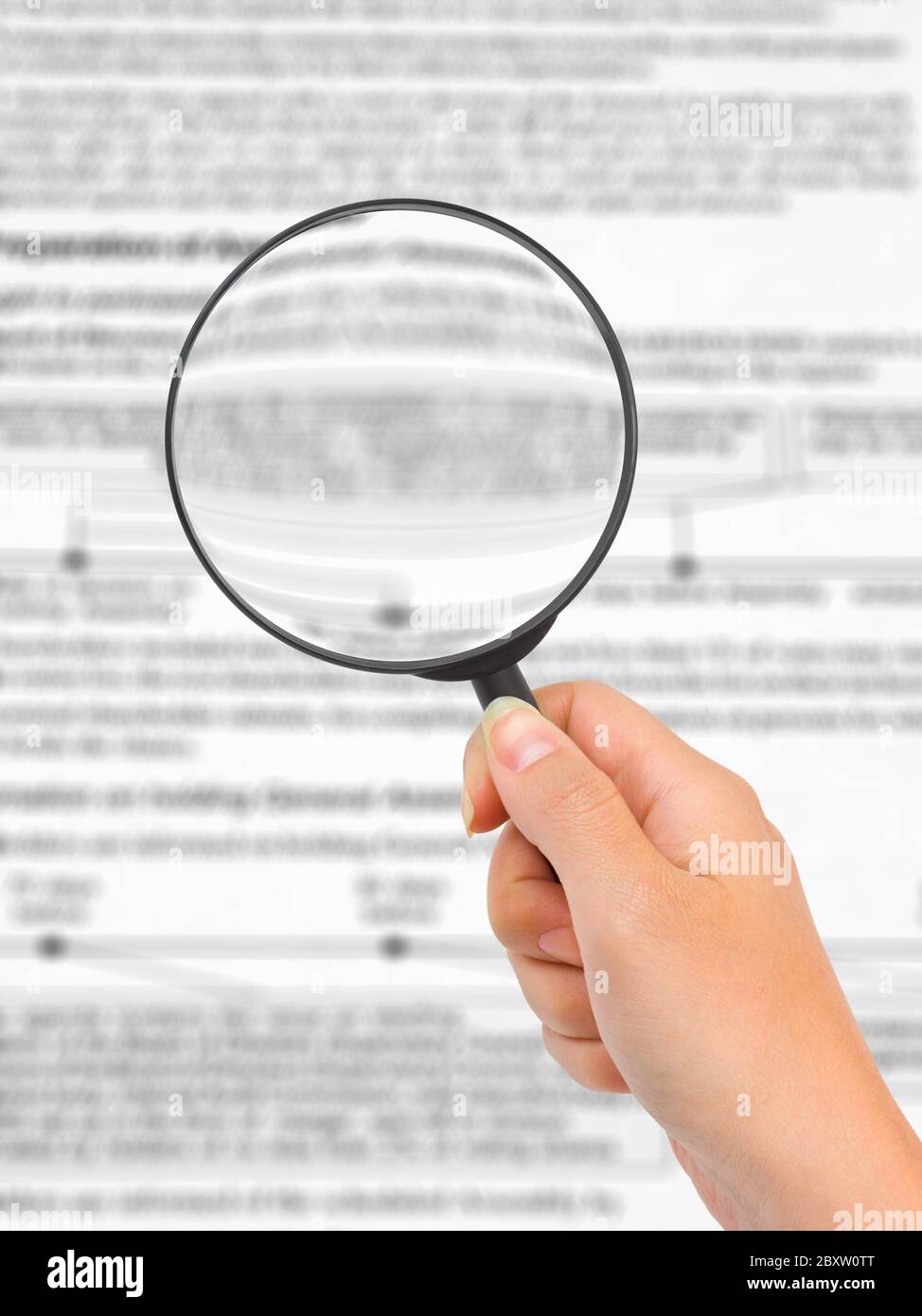 Magnifying glass in hand and business text Stock Photo - Alamy