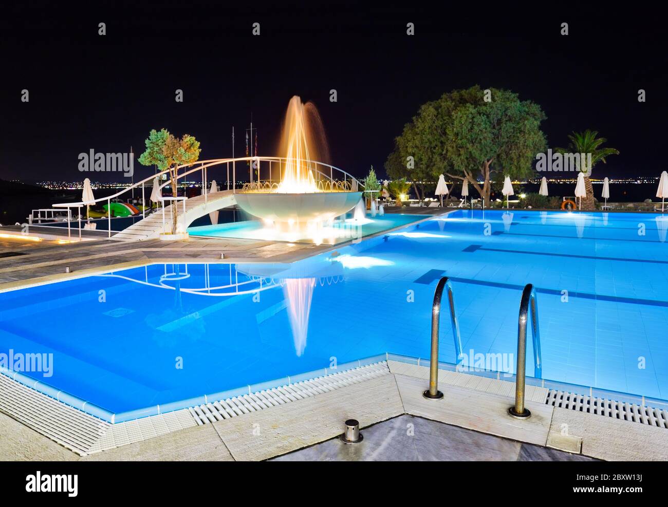 Water pool and fountain at night Stock Photo - Alamy