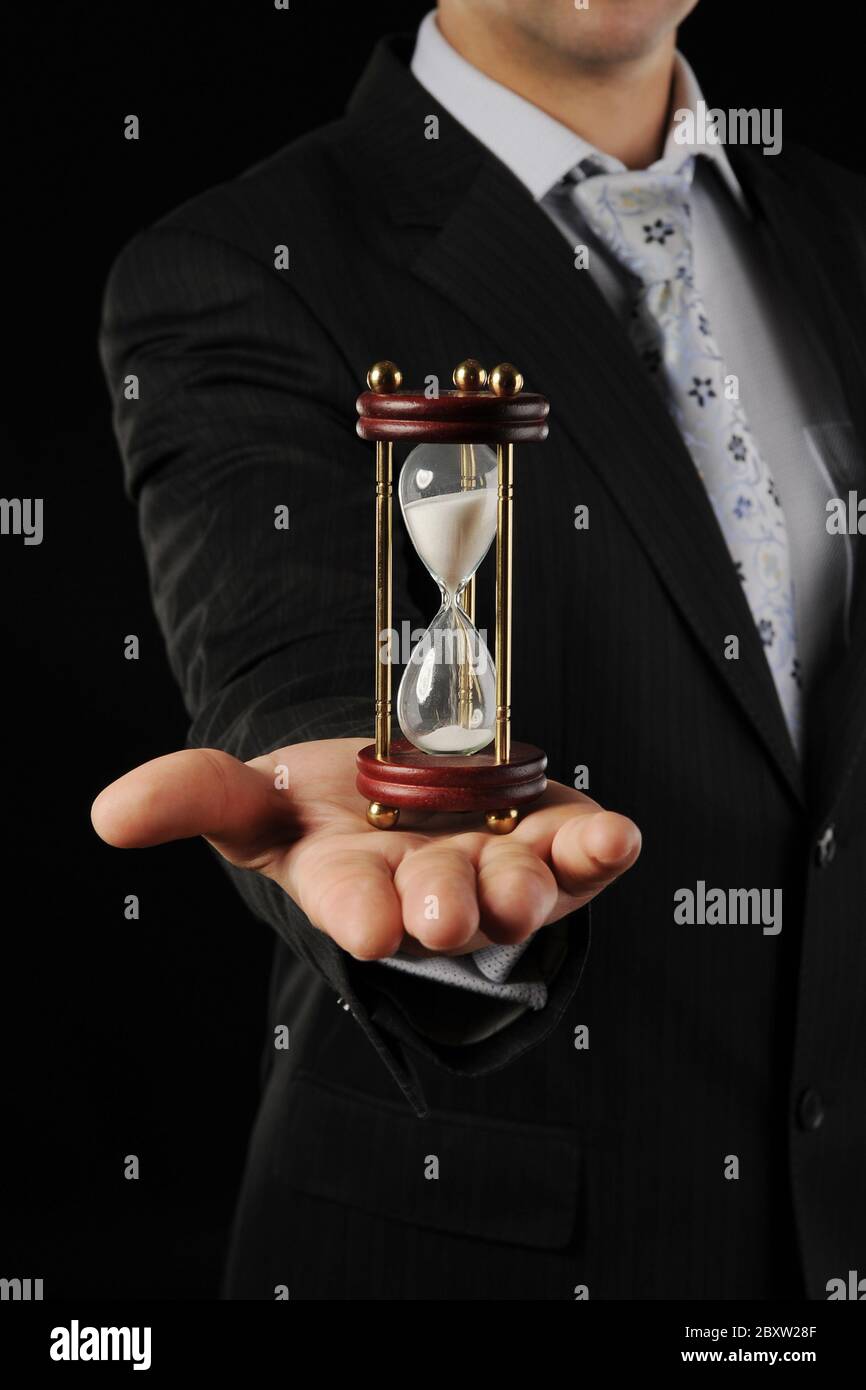 Male hand holding hourglass hi-res stock photography and images - Alamy
