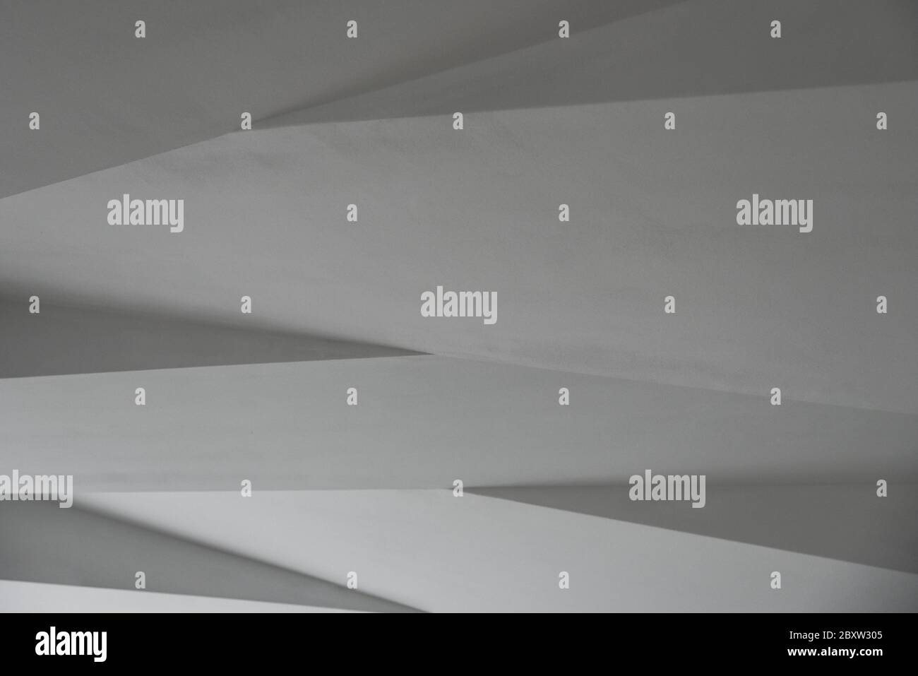 Ceiling with white triangular shapes Stock Photo - Alamy