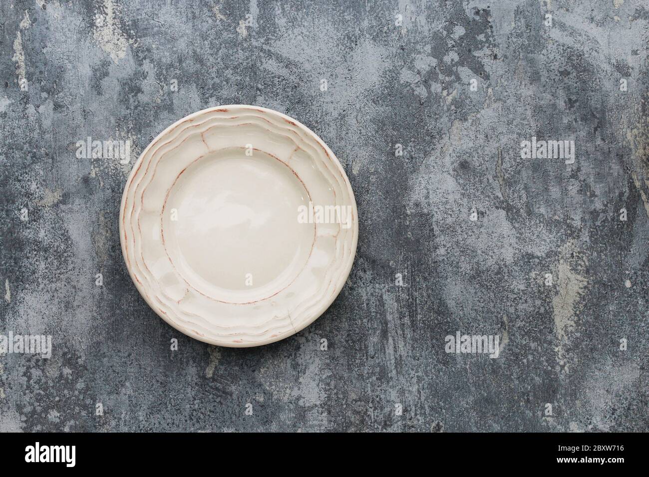 Top view of empty plate on grey, stone background. Graphic resources ...