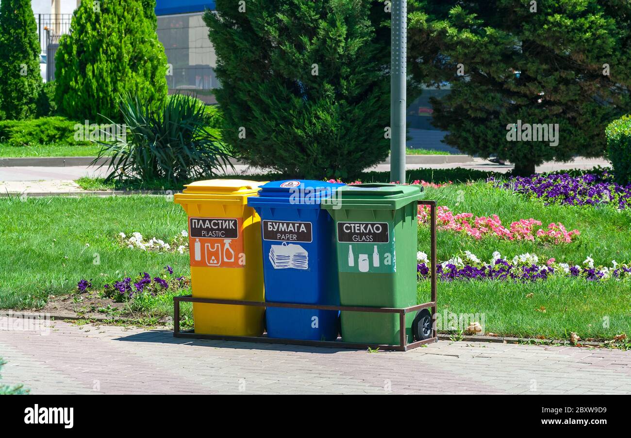 Three recycle containers for glass, plastic and paper on a city street ...