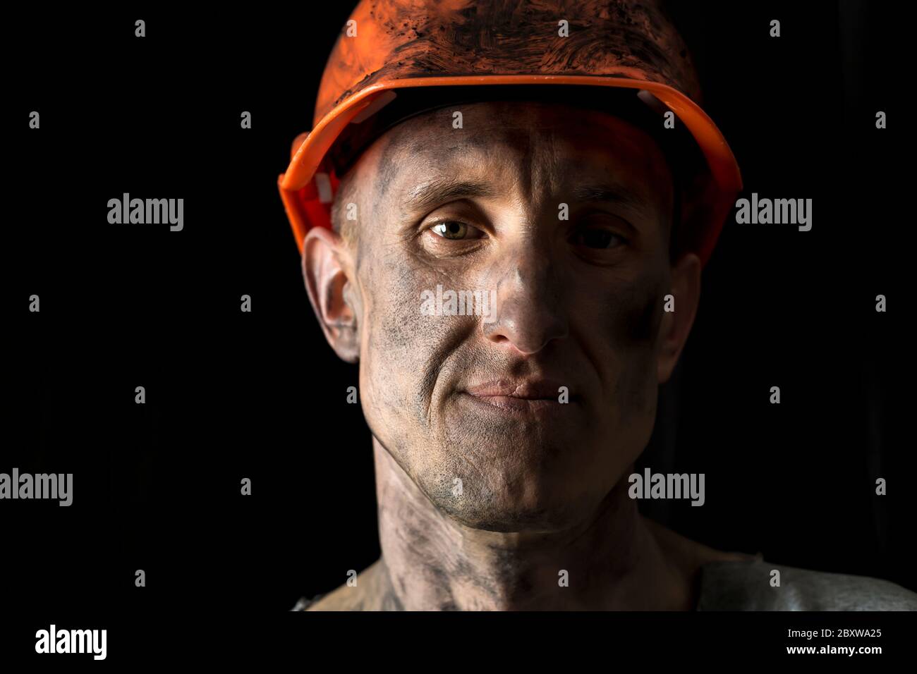 The face of a male miner in a helmet on a black background Stock Photo ...