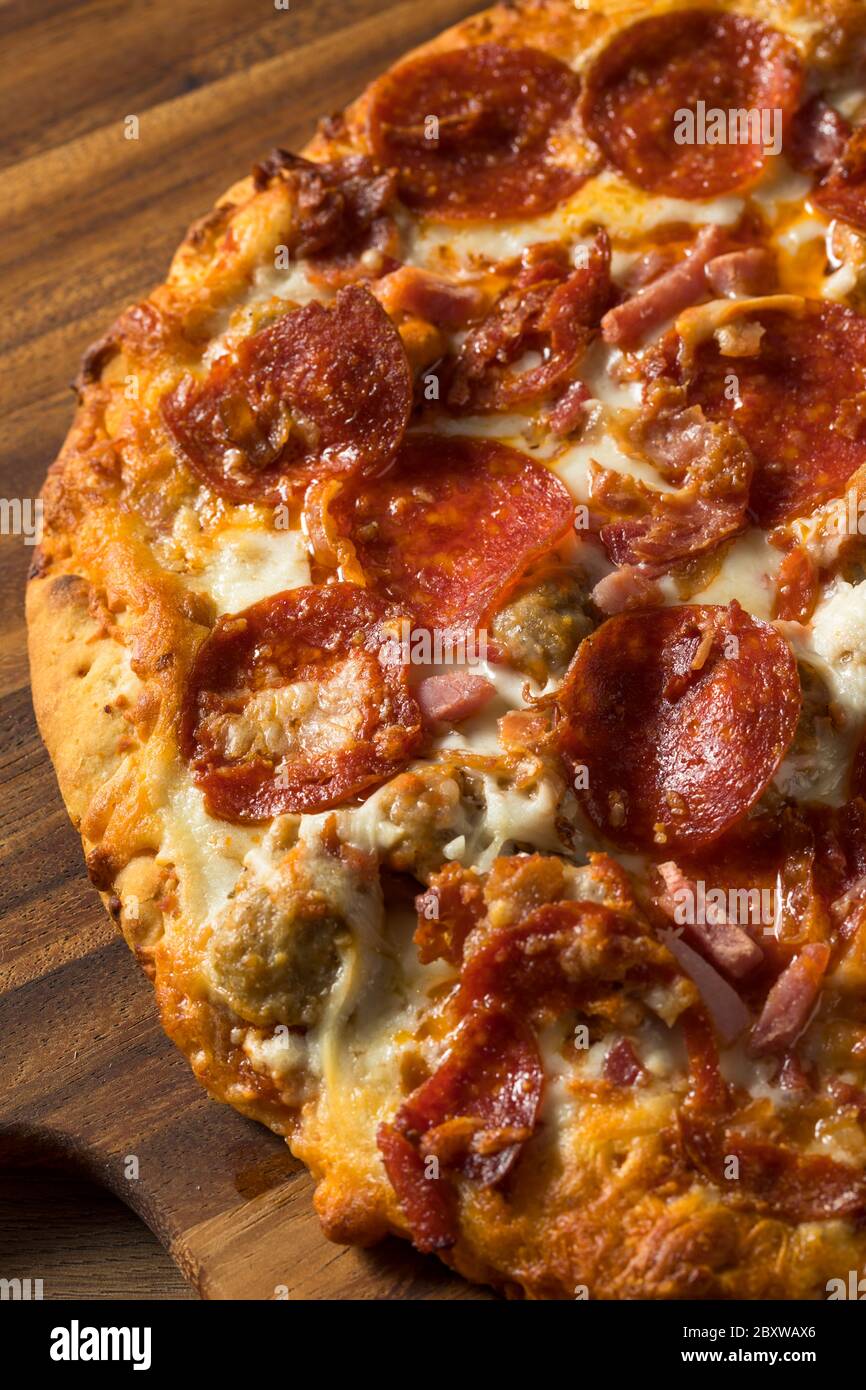 Savory Homemade Meat Lovers Pizza with Pepperoni and Bacon Stock Photo ...