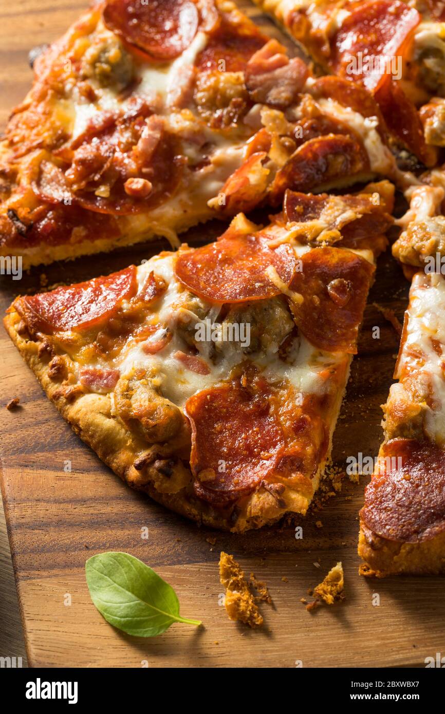 Savory Homemade Meat Lovers Pizza with Pepperoni and Bacon Stock Photo ...