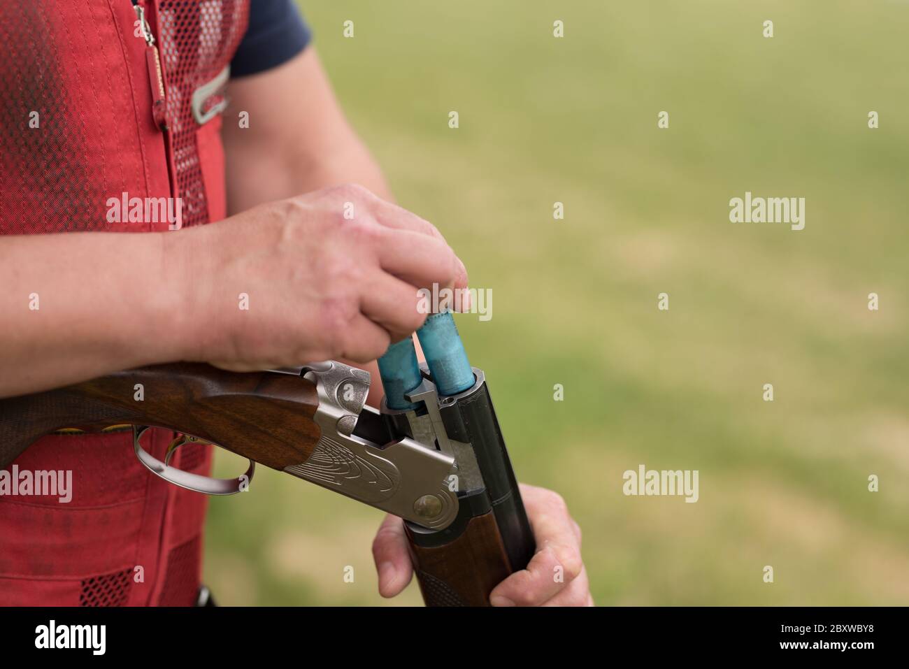 Close up of a man reloading his rifle Stock Photo - Alamy