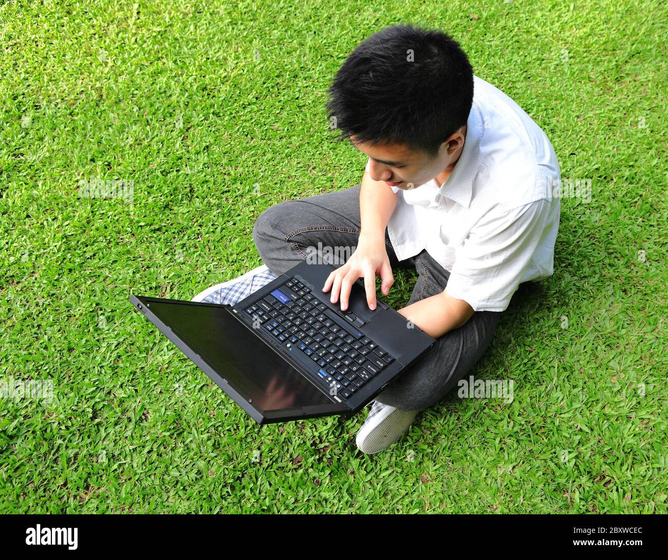asian man using computer outdoor Stock Photo - Alamy