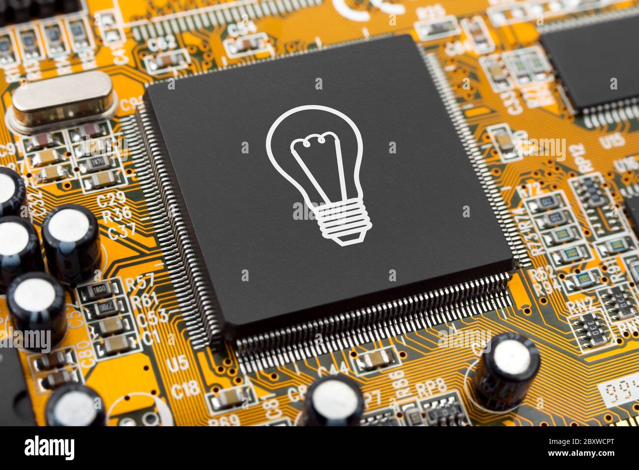 Bulb on computer chip Stock Photo - Alamy