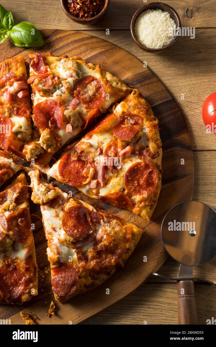 Savory Homemade Meat Lovers Pizza with Pepperoni and Bacon Stock Photo ...