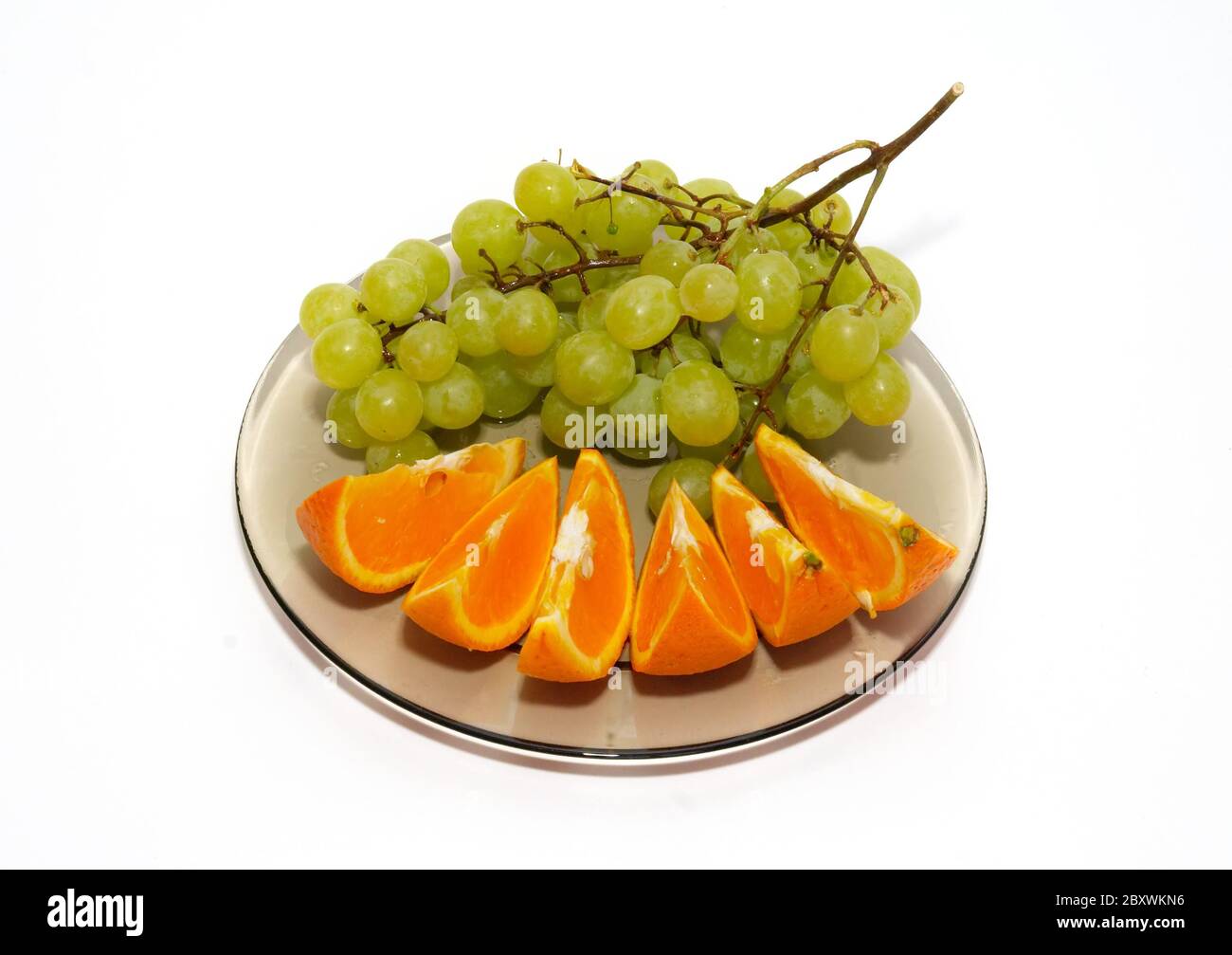 Green grapes and orange isolated on white Stock Photo - Alamy