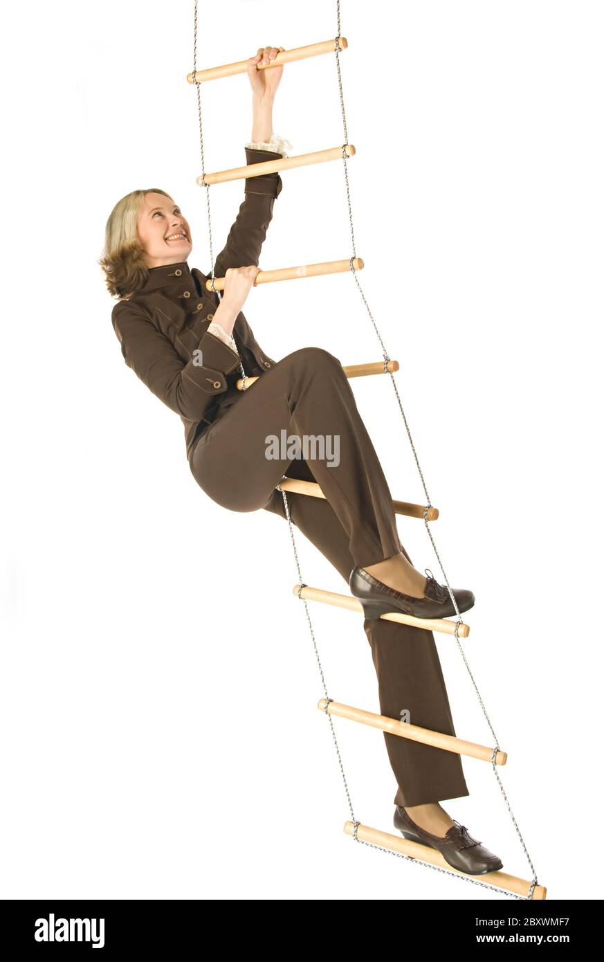 An isolated photo of a businesswoman climbing a rope-ladder Stock Photo ...