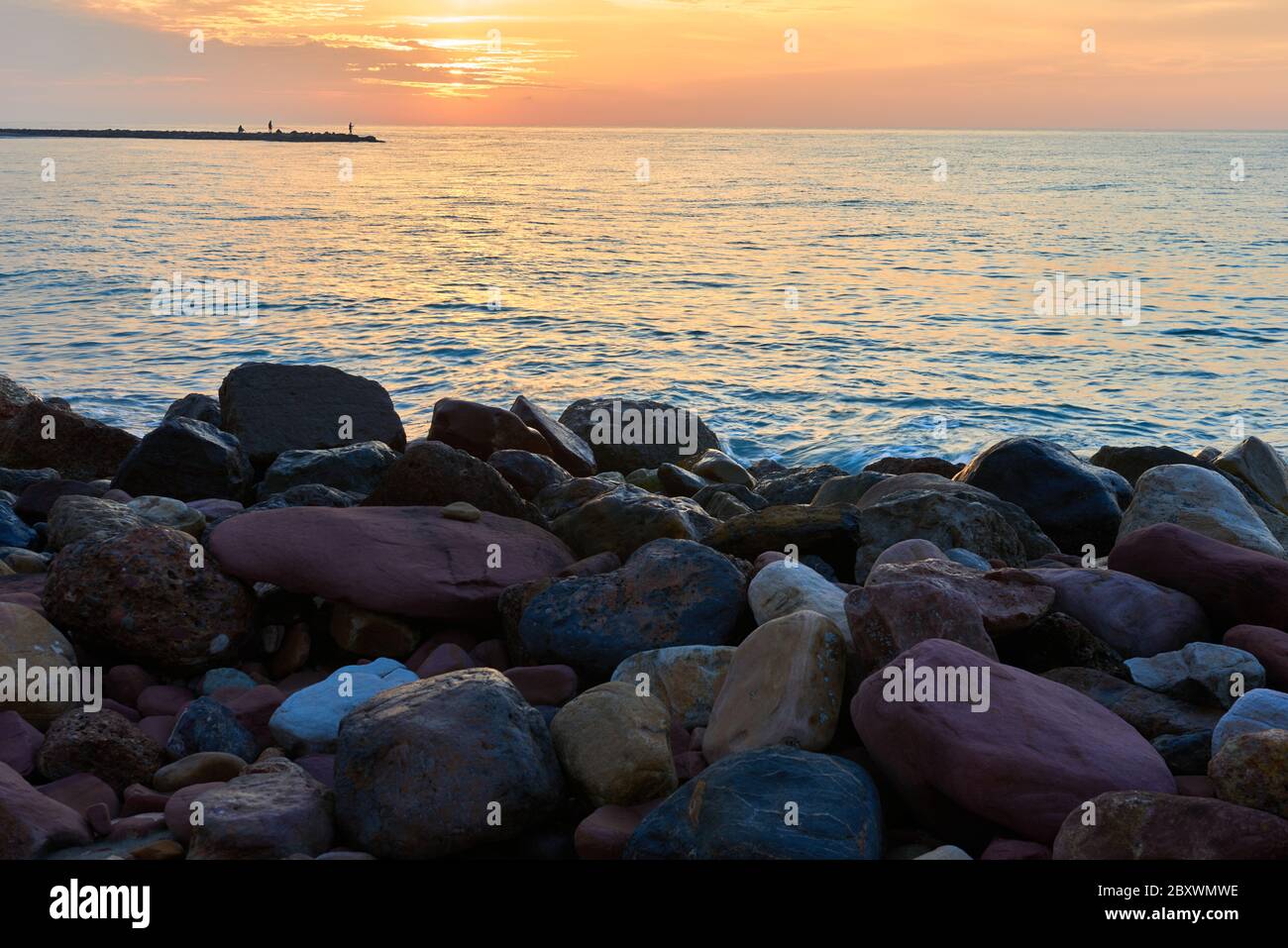 Some rocks of different colors on the beach Stock Photo - Alamy