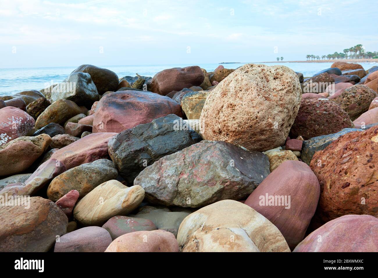 Some rocks of different colors on the beach Stock Photo - Alamy