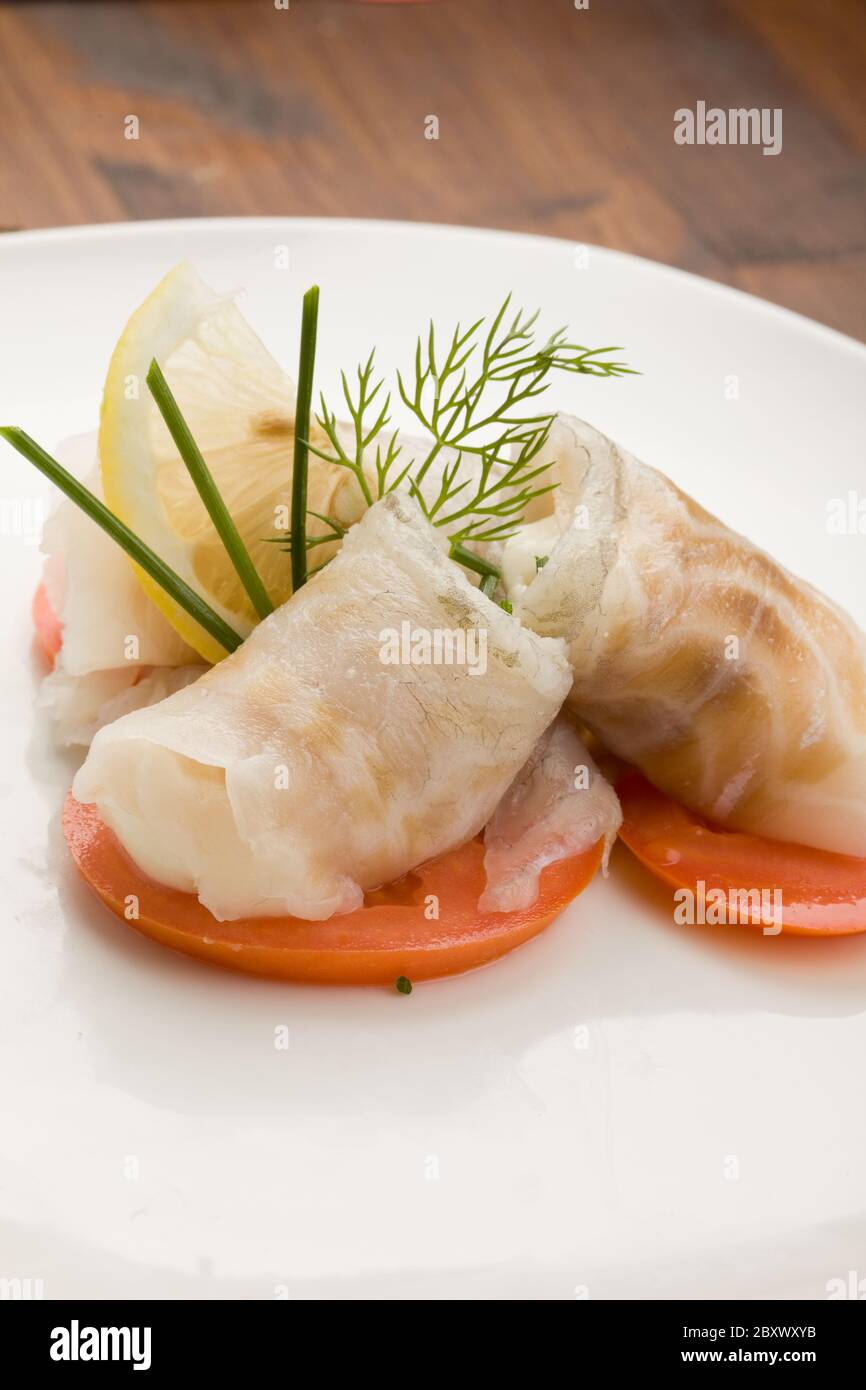Sea Bass rolls with tomatoes Stock Photo - Alamy
