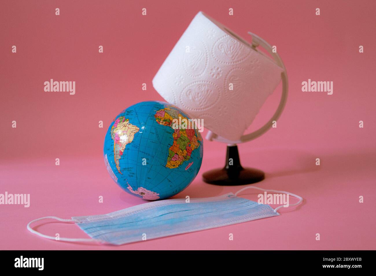 Earth globe ,toilet paper and face mask on pink background Stock Photo ...