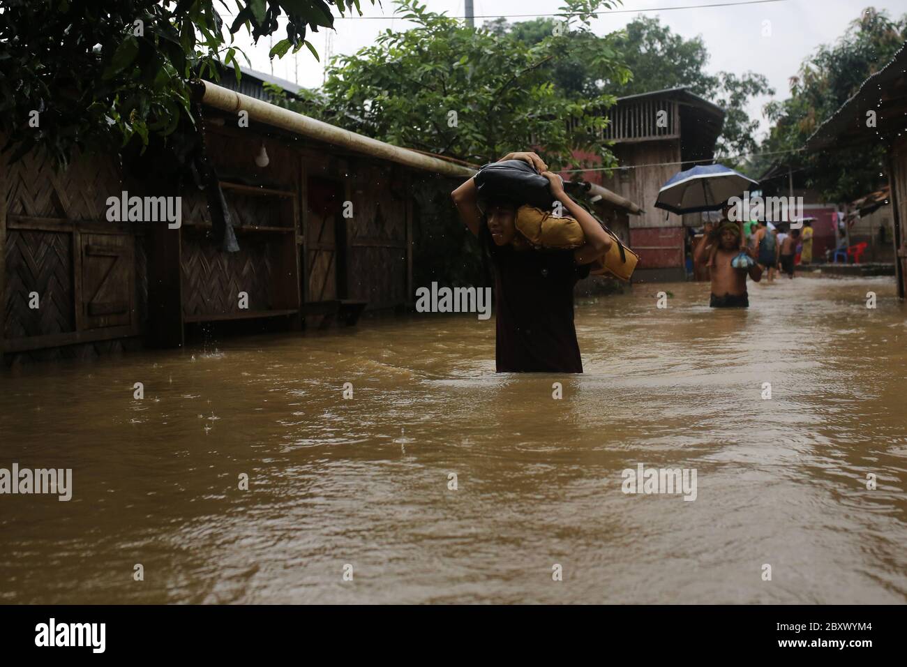 Flood affected indigenous people move toward the shelter center in ...