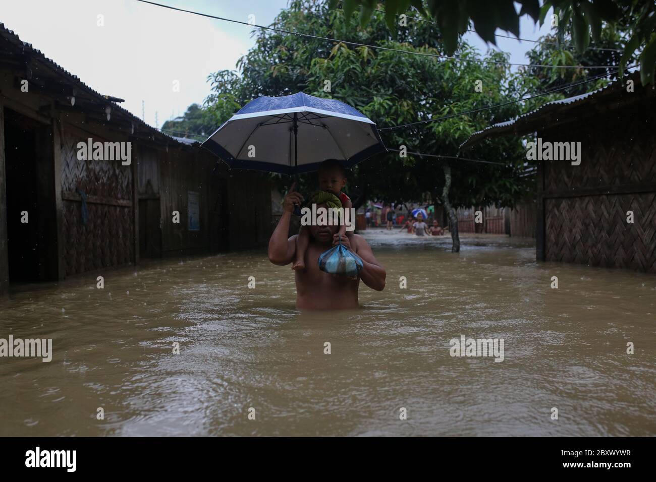 Flood affected indigenous people move toward the shelter center in ...