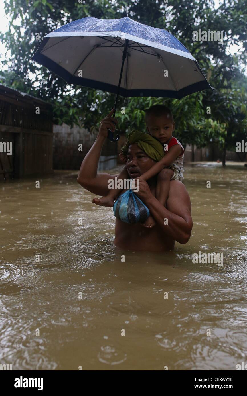 Flood affected indigenous people move toward the shelter center in Bandarban, Bangladesh on July ...