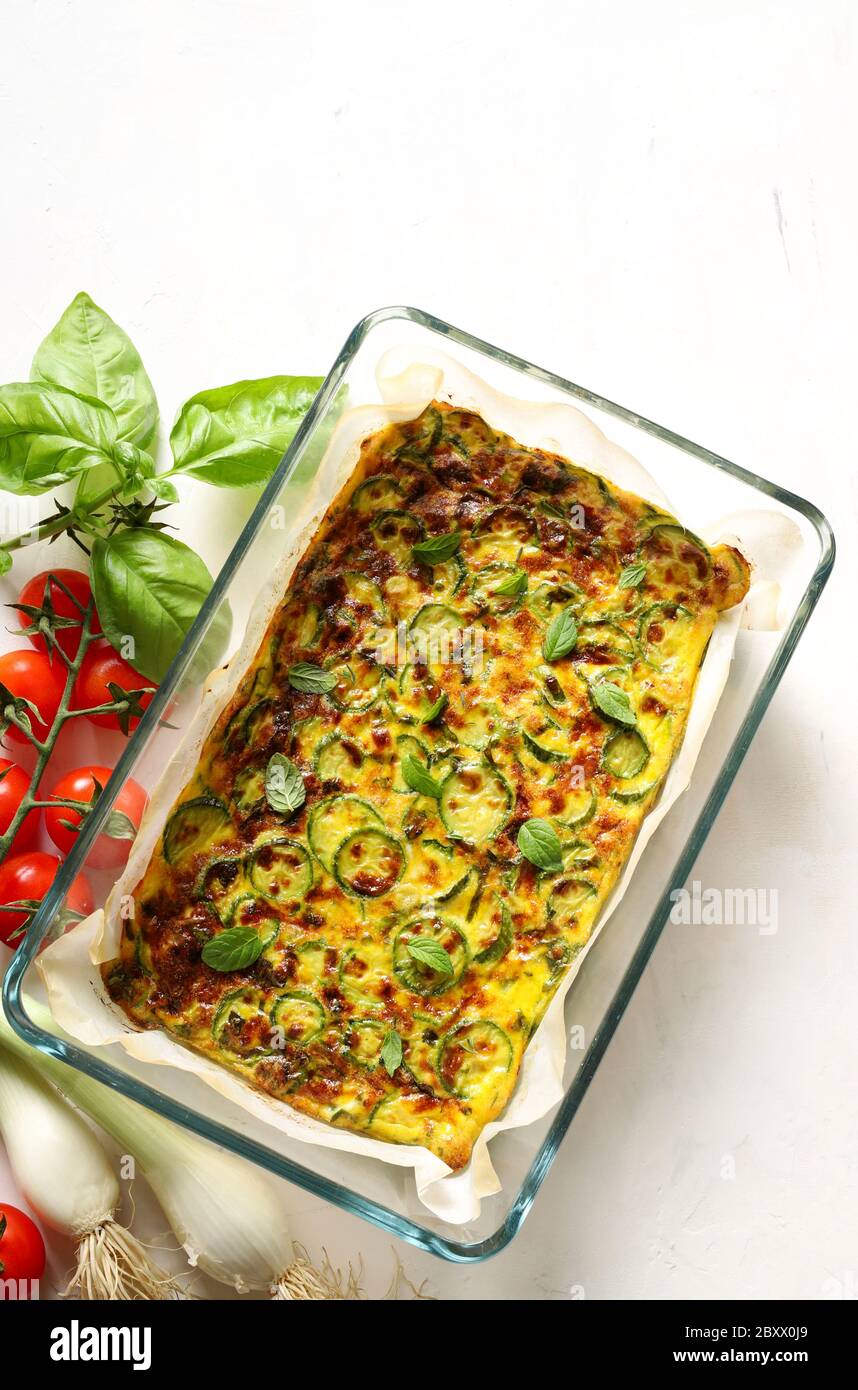 Food concept. Oven baked omelette with zucchini, leeks and cheese in a ...