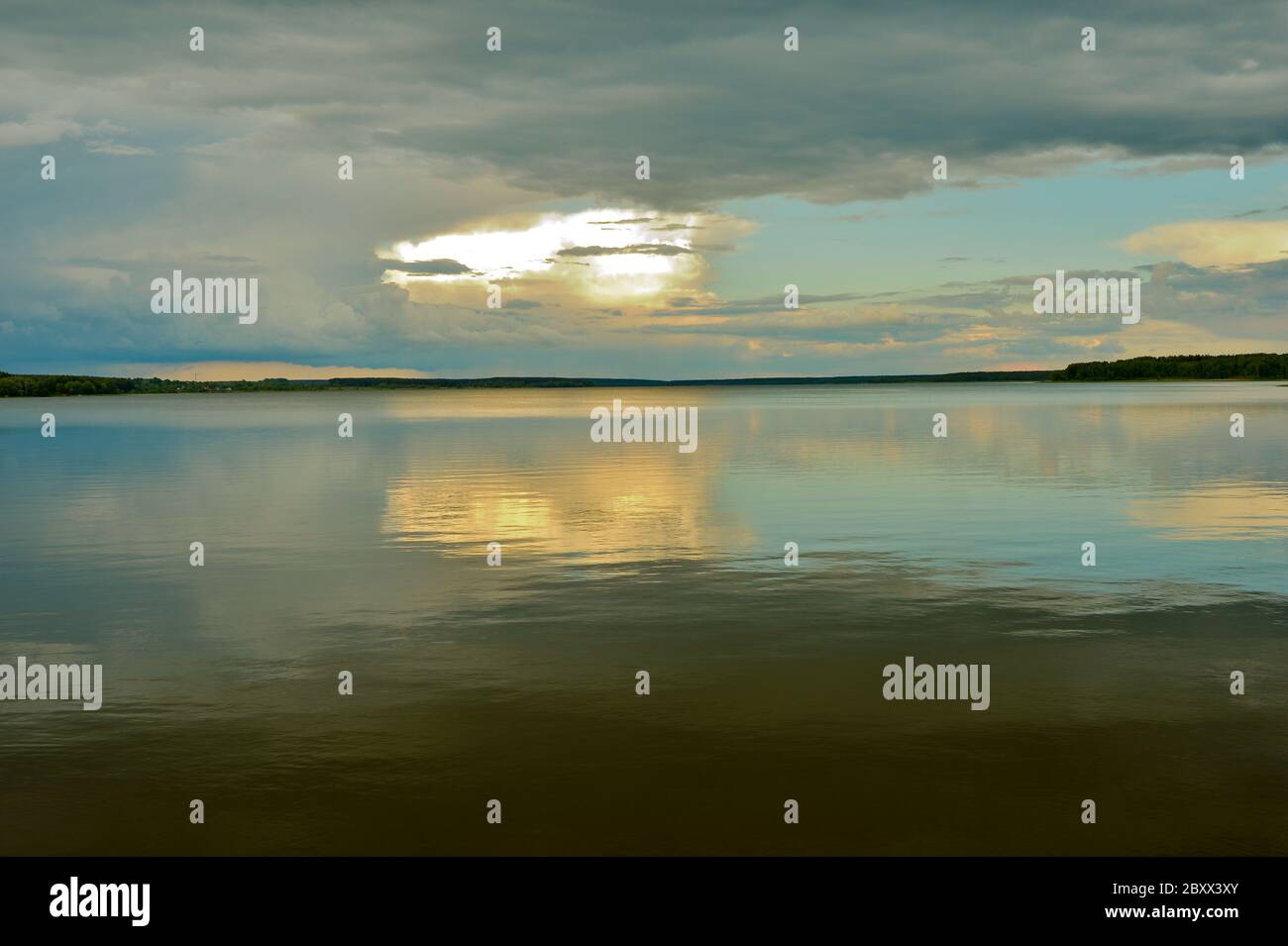 A calm evening sky landscape of pastel colors with a reflection in the ...