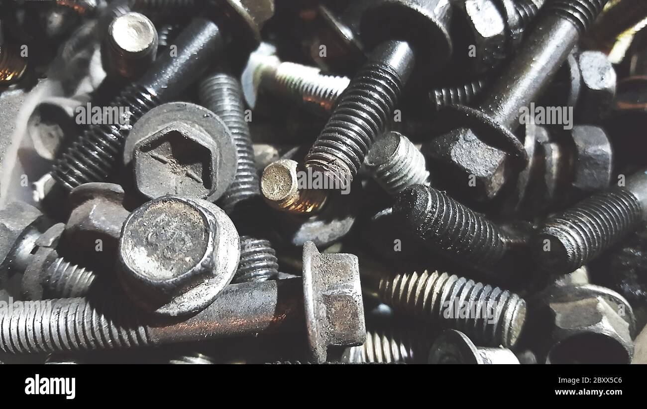 Different metal threaded bolts in oil. Grunge background Stock Photo ...