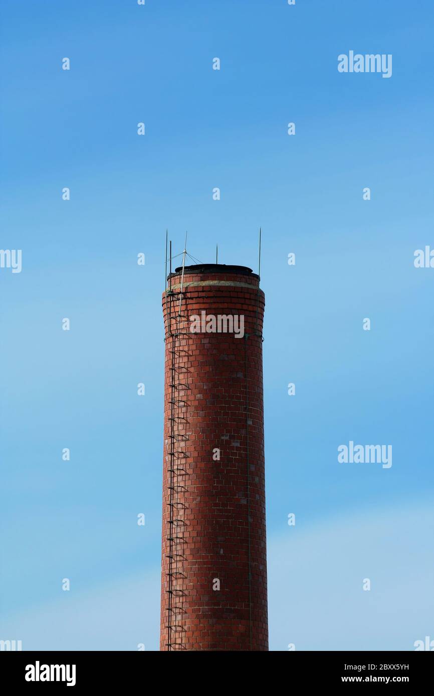 A Red brick smokestack with blue sky Stock Photo - Alamy