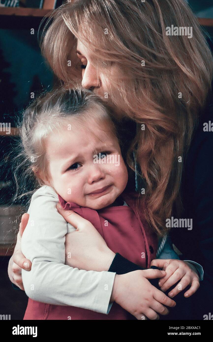 Mother hugging a crying baby. Family care concept Stock Photo - Alamy