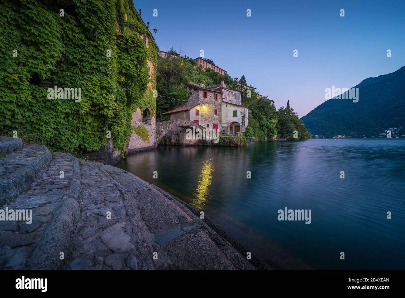 Scenic picture of Nesso on the Como lake in Italy with stone foreground ...