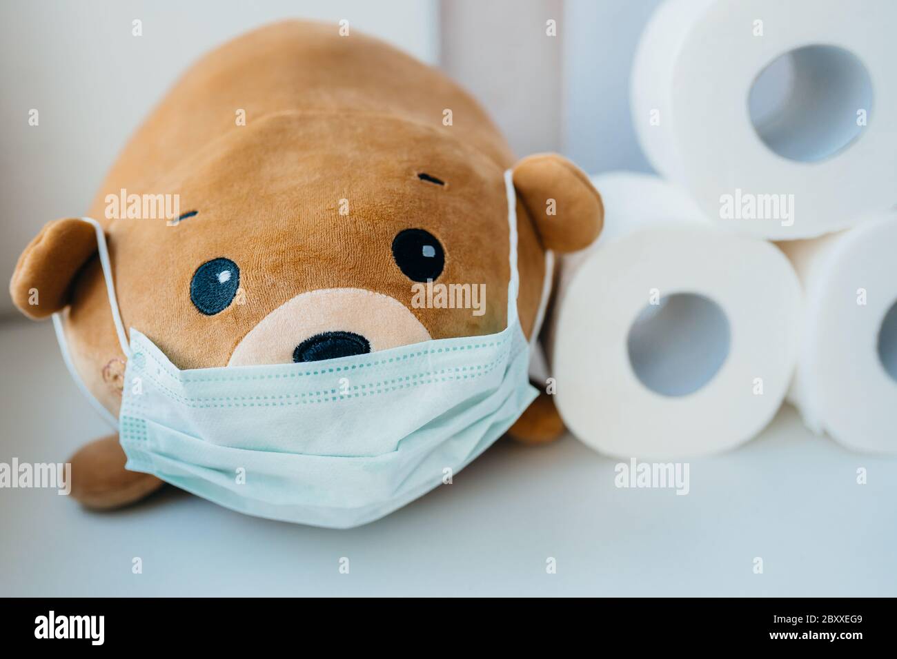 Disposable medical protective face mask on brown teddy bear Stock Photo ...