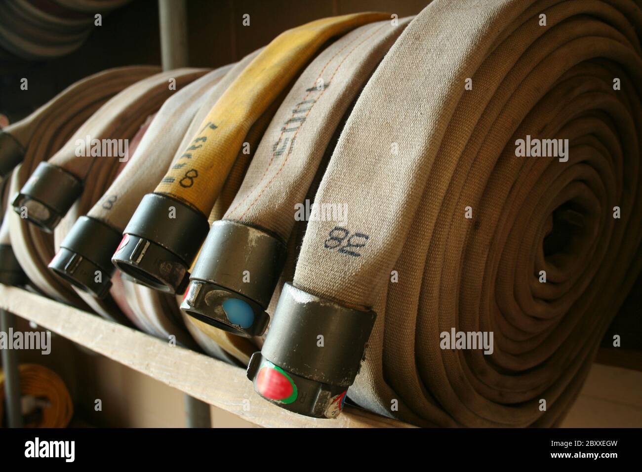 Fire Hoses lined up inside a firehouse Stock Photo - Alamy
