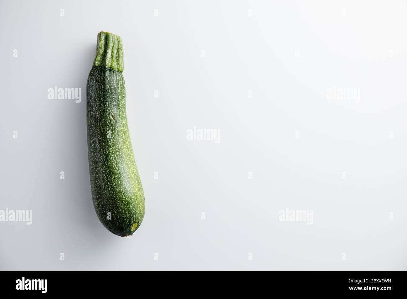 Zucchini on a white background. Minimum concept Stock Photo - Alamy