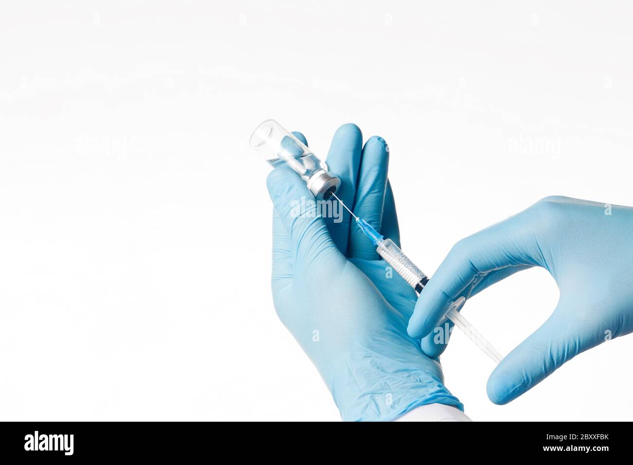 Close up doctor arm using syringe and ampoule on white background ...