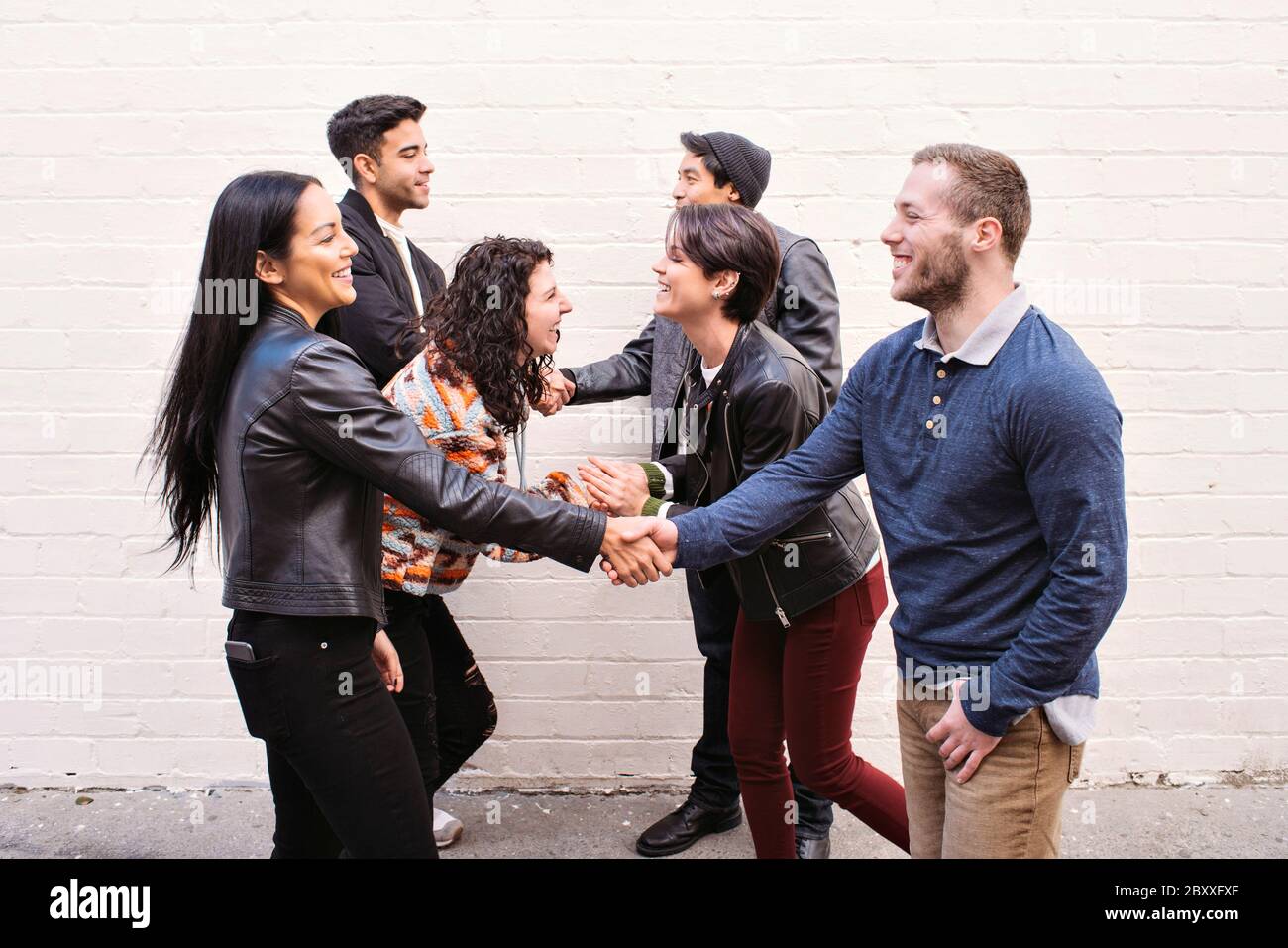 Six friends reunite and shake hands in the city - Happy - Friendly ...