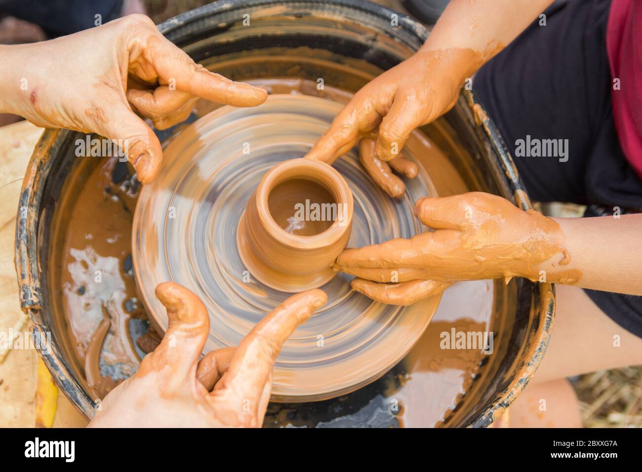 A close up view on ceramic production process on potter's wheel with ...