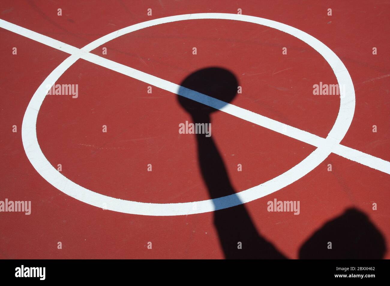 A Shadow Basketball player jump ball on red court Stock Photo - Alamy