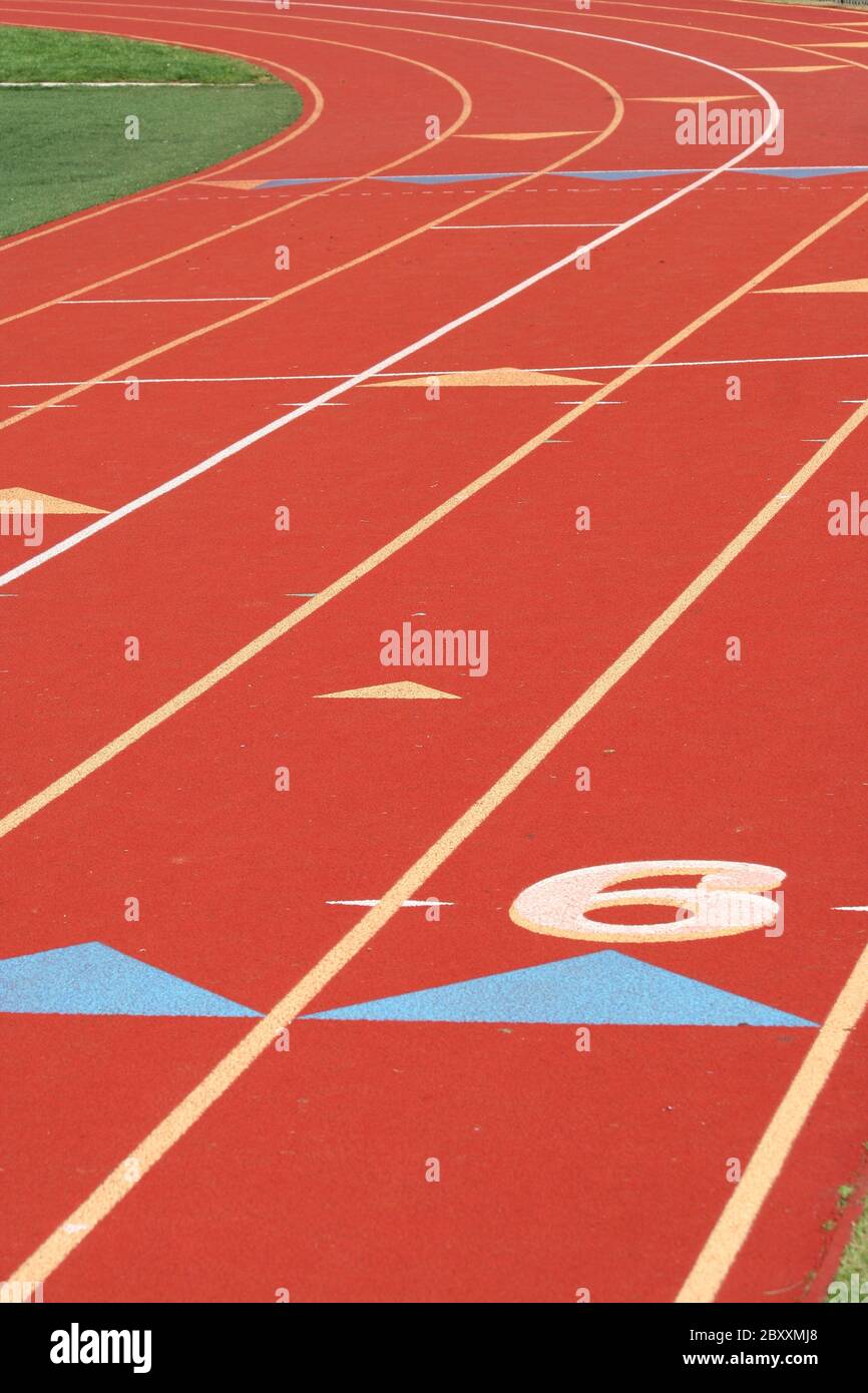 Red running track lanes Stock Photo - Alamy