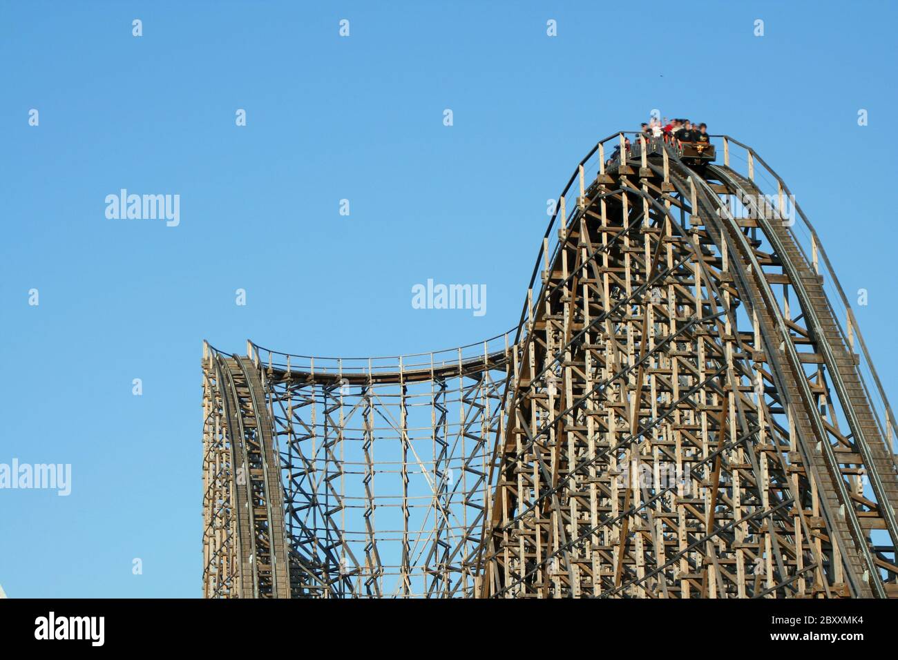 Wooden roller coaster support beams against blue sky Stock Photo - Alamy