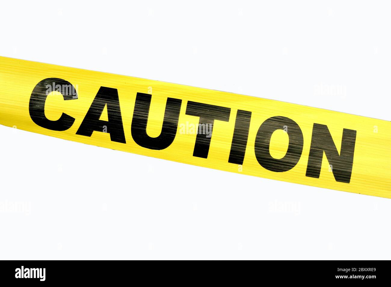 Yellow Caution Tape against a white background Stock Photo - Alamy
