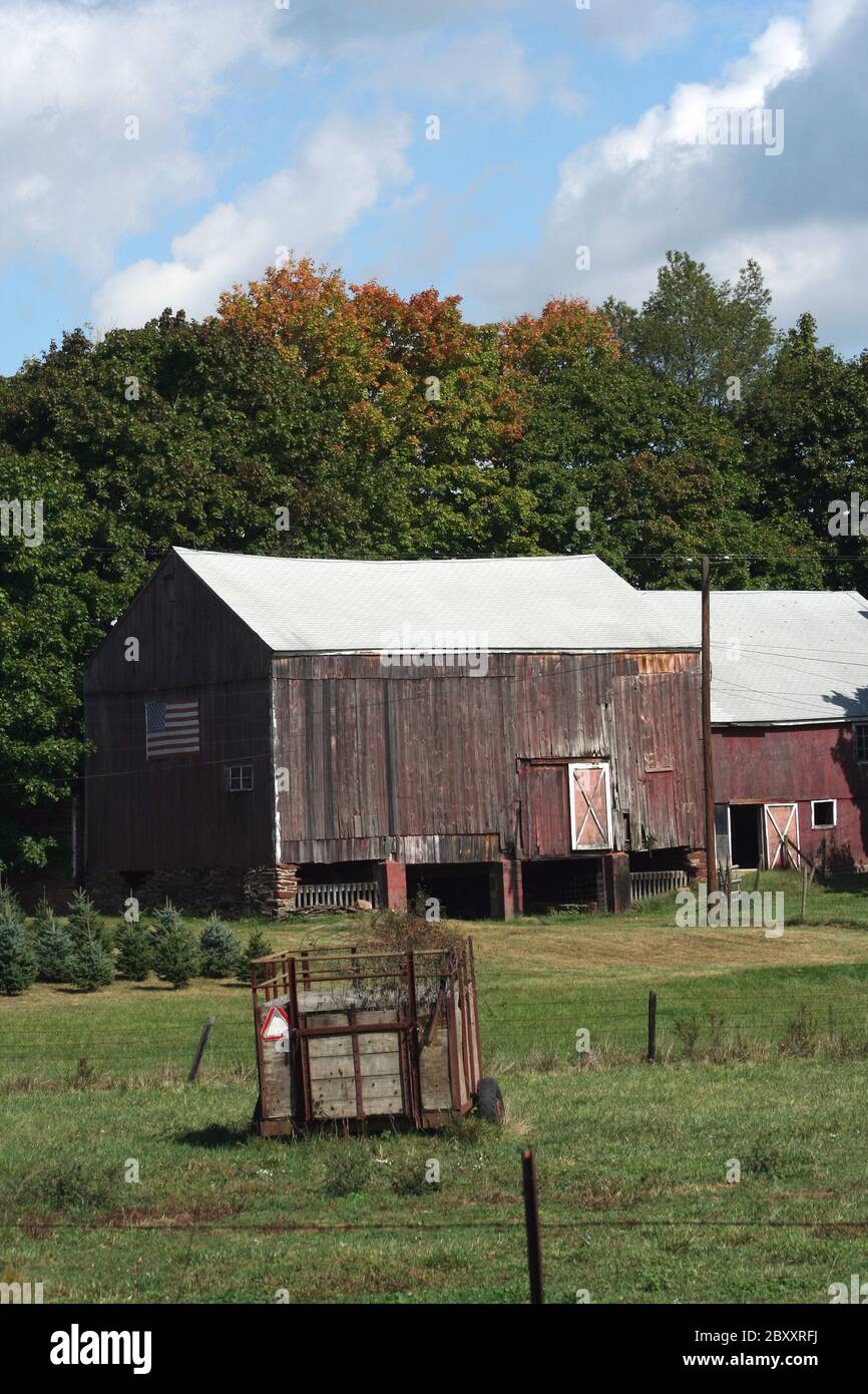 An old barn with a wagon and trees Stock Photo - Alamy