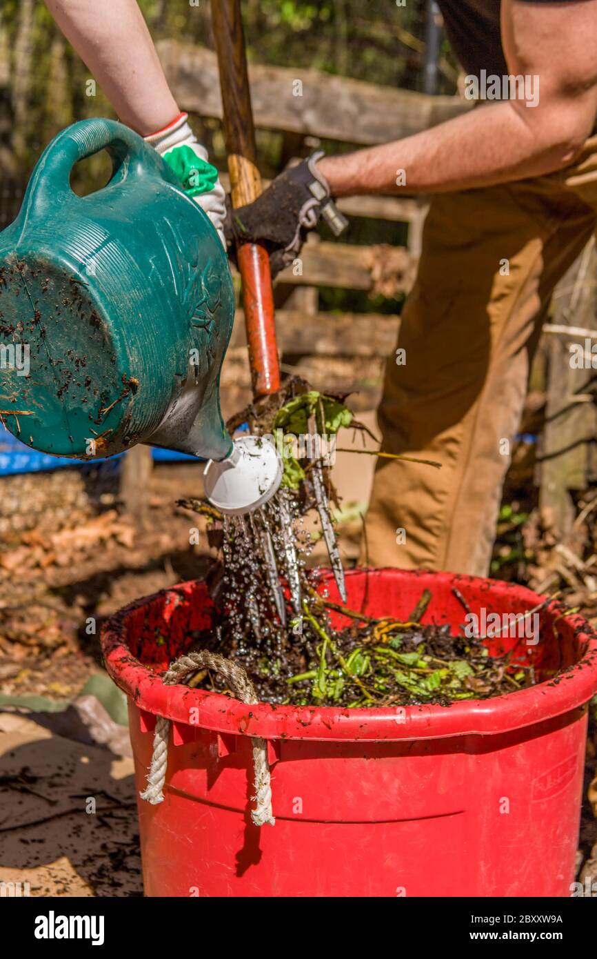 Pouring water bucket hi-res stock photography and images - Alamy